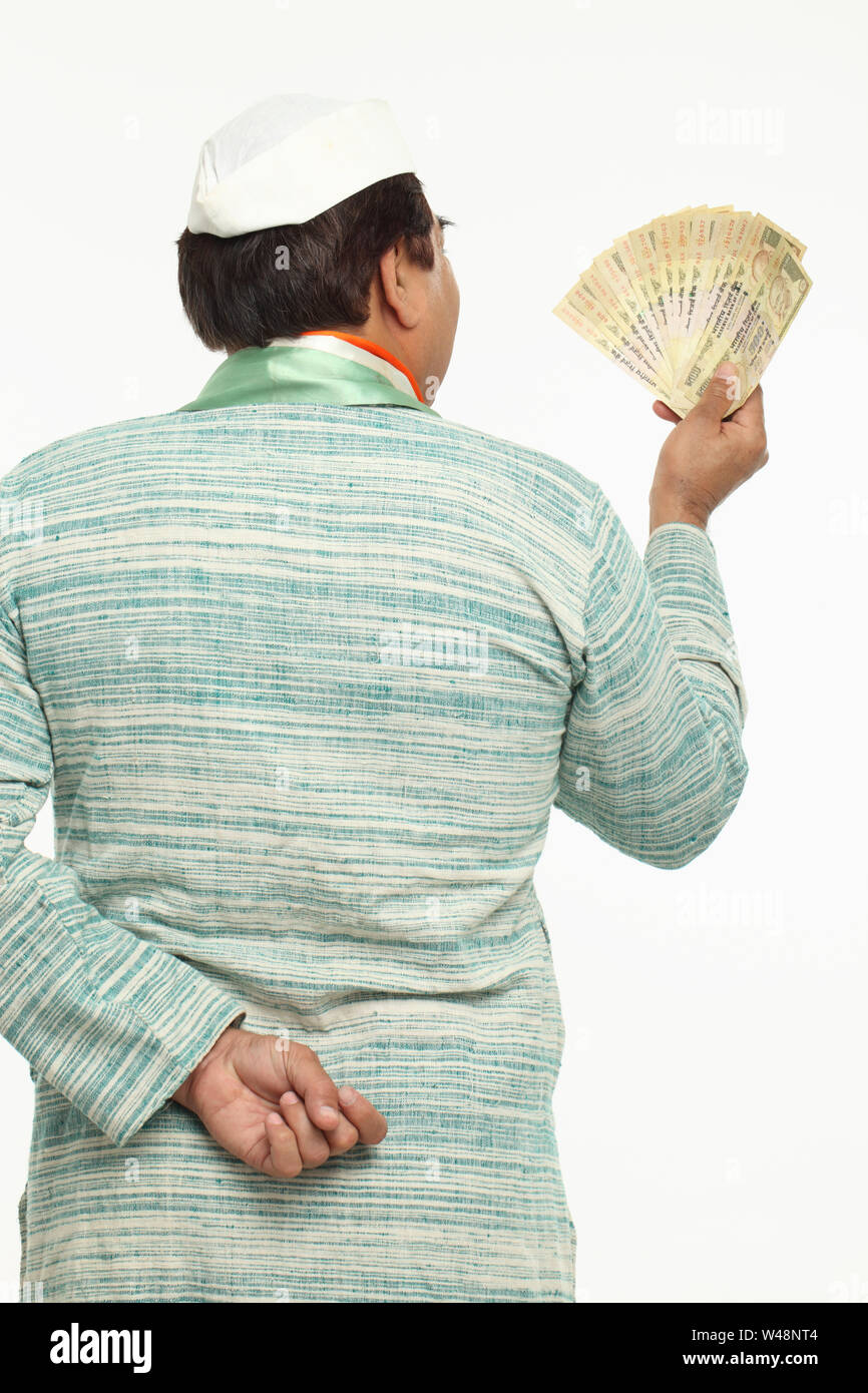 Rear view of a politician showing five hundred rupee banknotes Stock ...