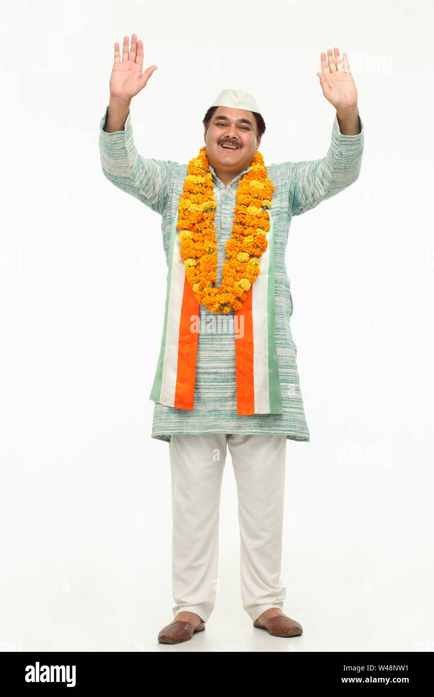 Politician standing with his arms raised Stock Photo - Alamy