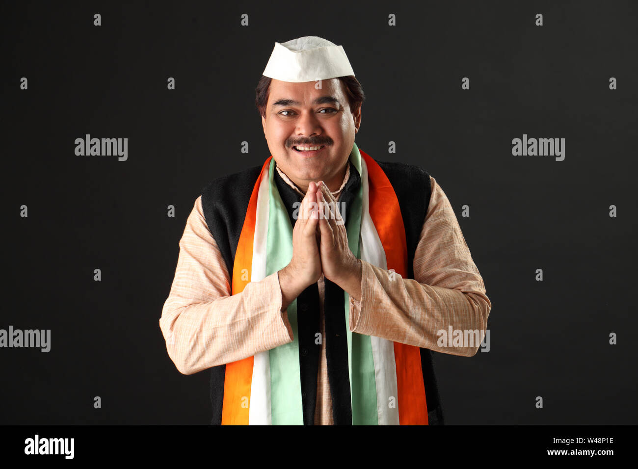 Politician welcoming with hands joined Stock Photo - Alamy
