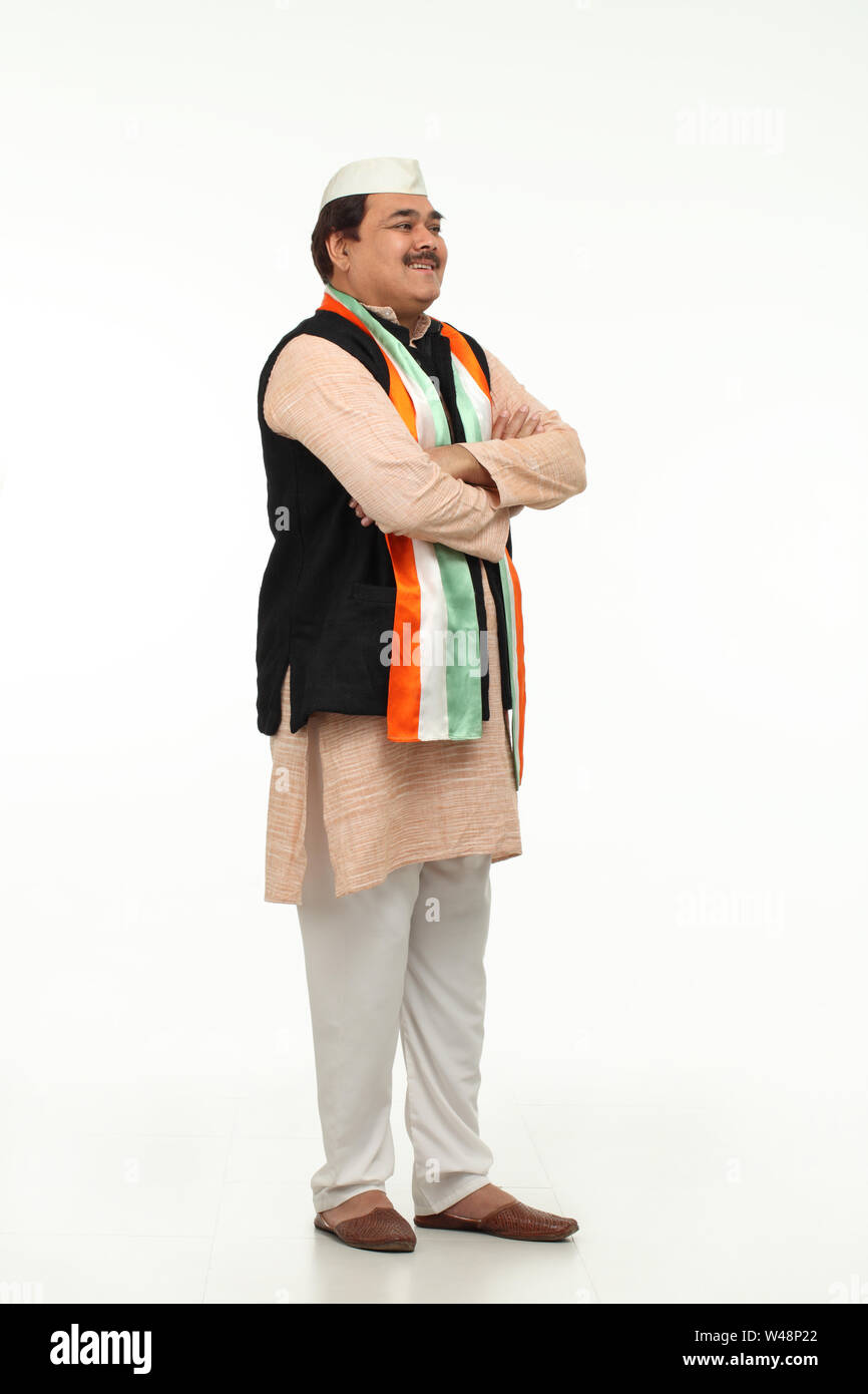 Politician standing with arms crossed and smiling Stock Photo - Alamy