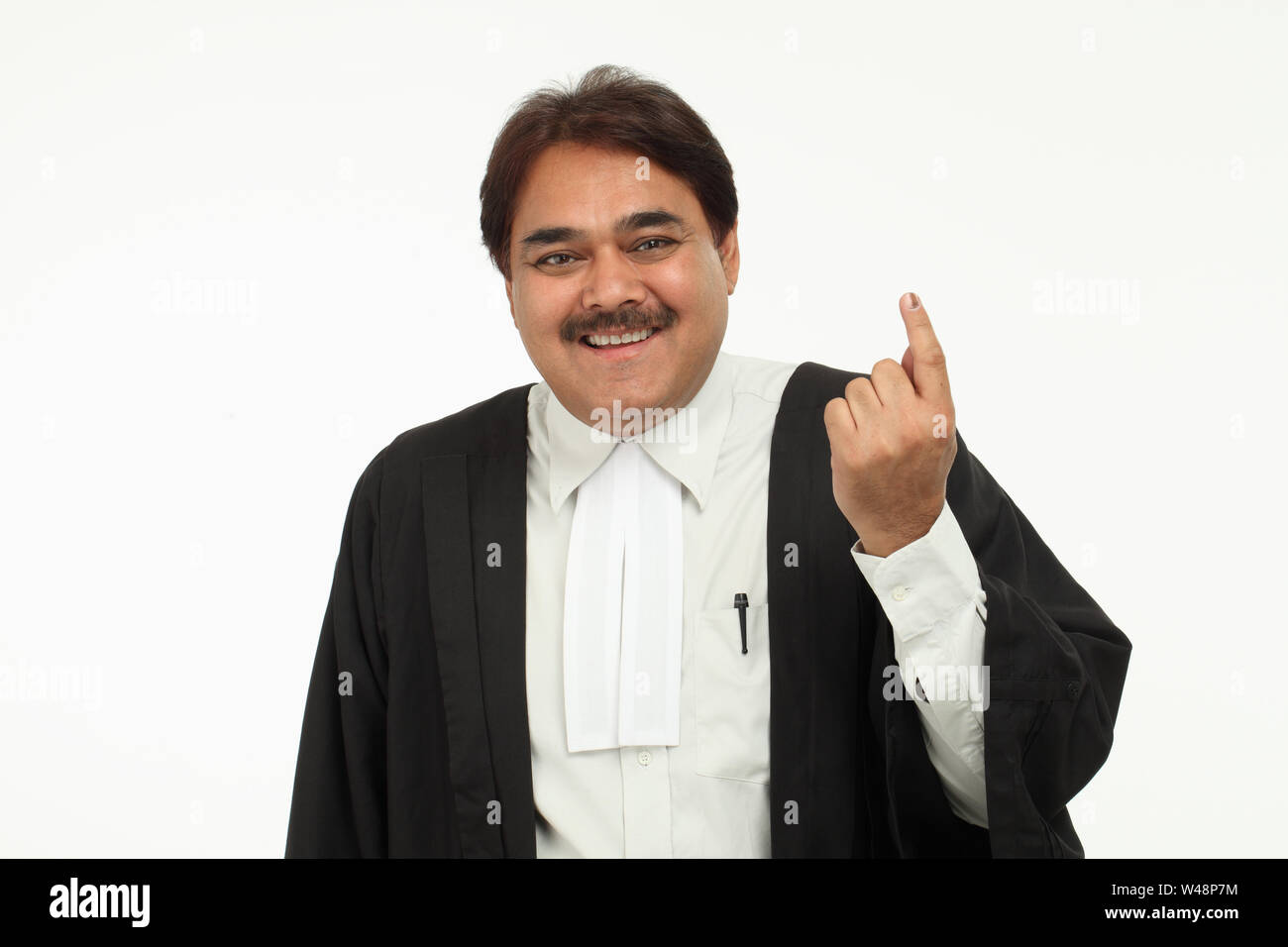 Indian lawyer smiling and pointing upward Stock Photo - Alamy