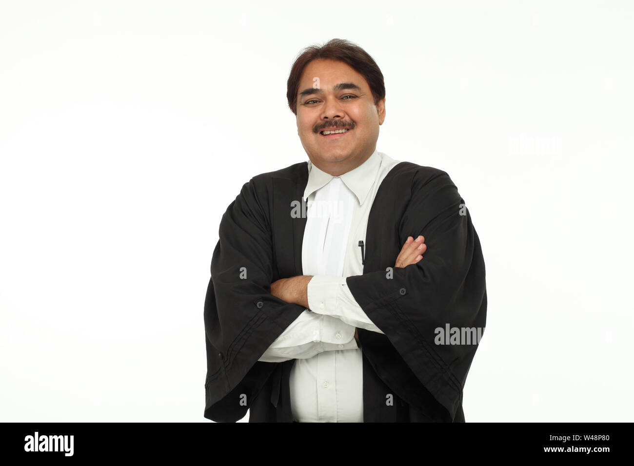Lawyer smiling with his arms crossed Stock Photo - Alamy