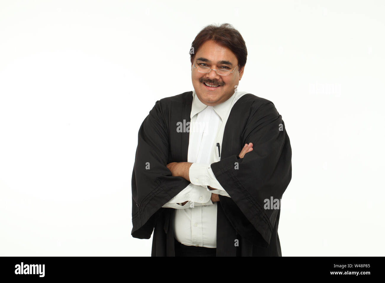 Lawyer smiling with his arms crossed Stock Photo - Alamy