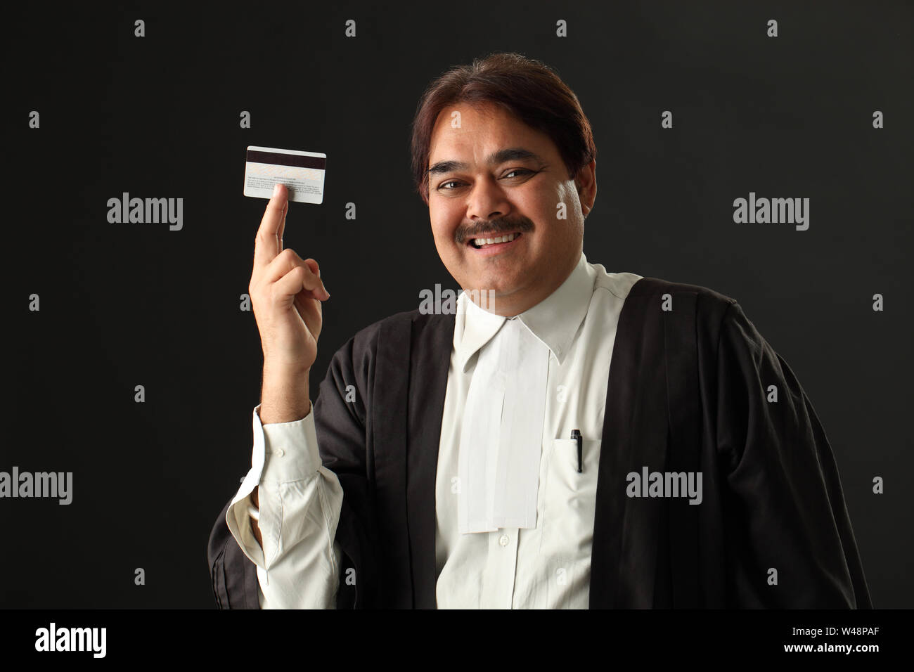 Lawyer showing a credit card and smiling Stock Photo - Alamy