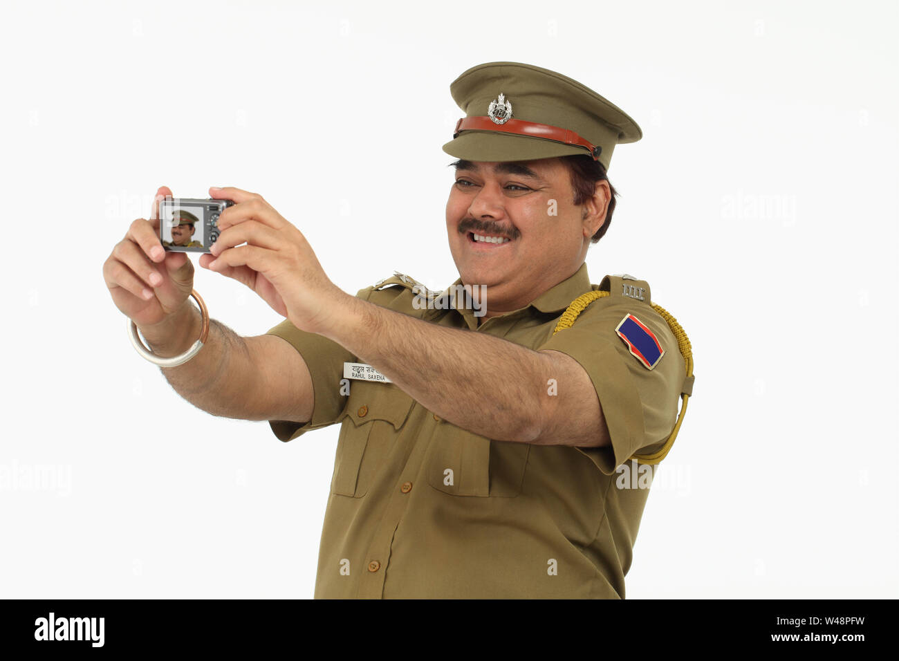 Indian policeman taking picture with digital camera Stock Photo - Alamy
