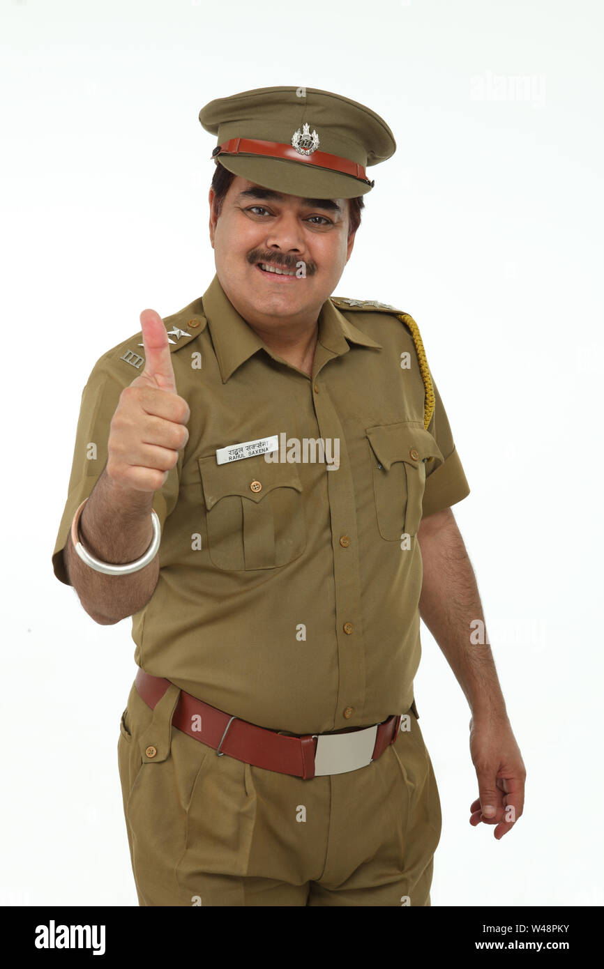 Policeman showing thumbs up sign Stock Photo - Alamy