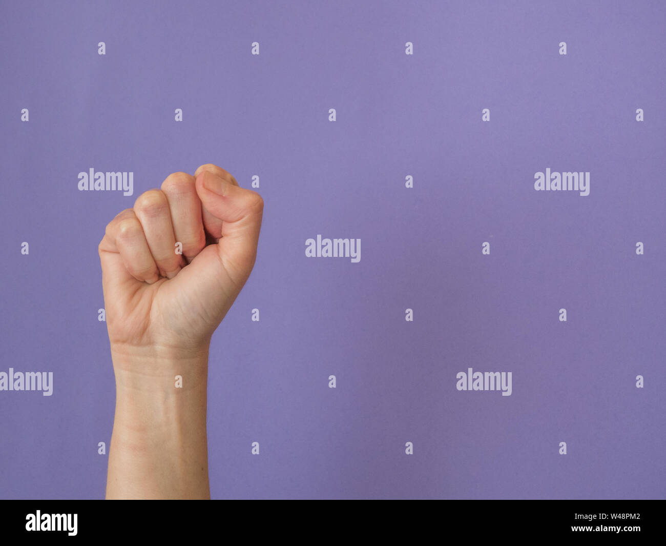 Woman arm clenched fist hi-res stock photography and images - Alamy