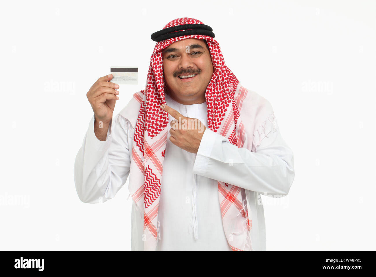 Arabian man showing credit card and smiling Stock Photo - Alamy
