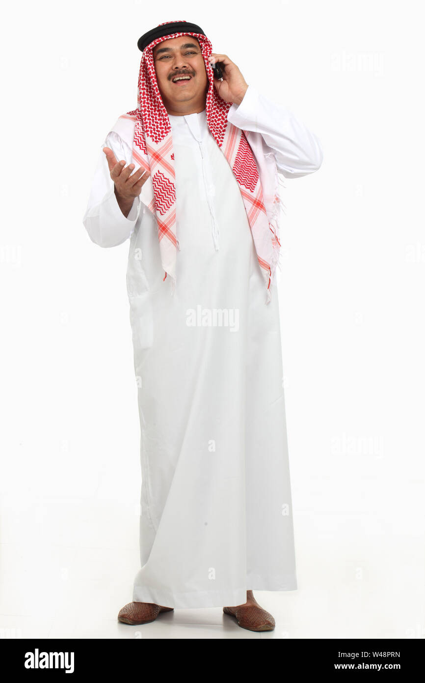 Arabian man talking on a mobile phone and smiling Stock Photo - Alamy