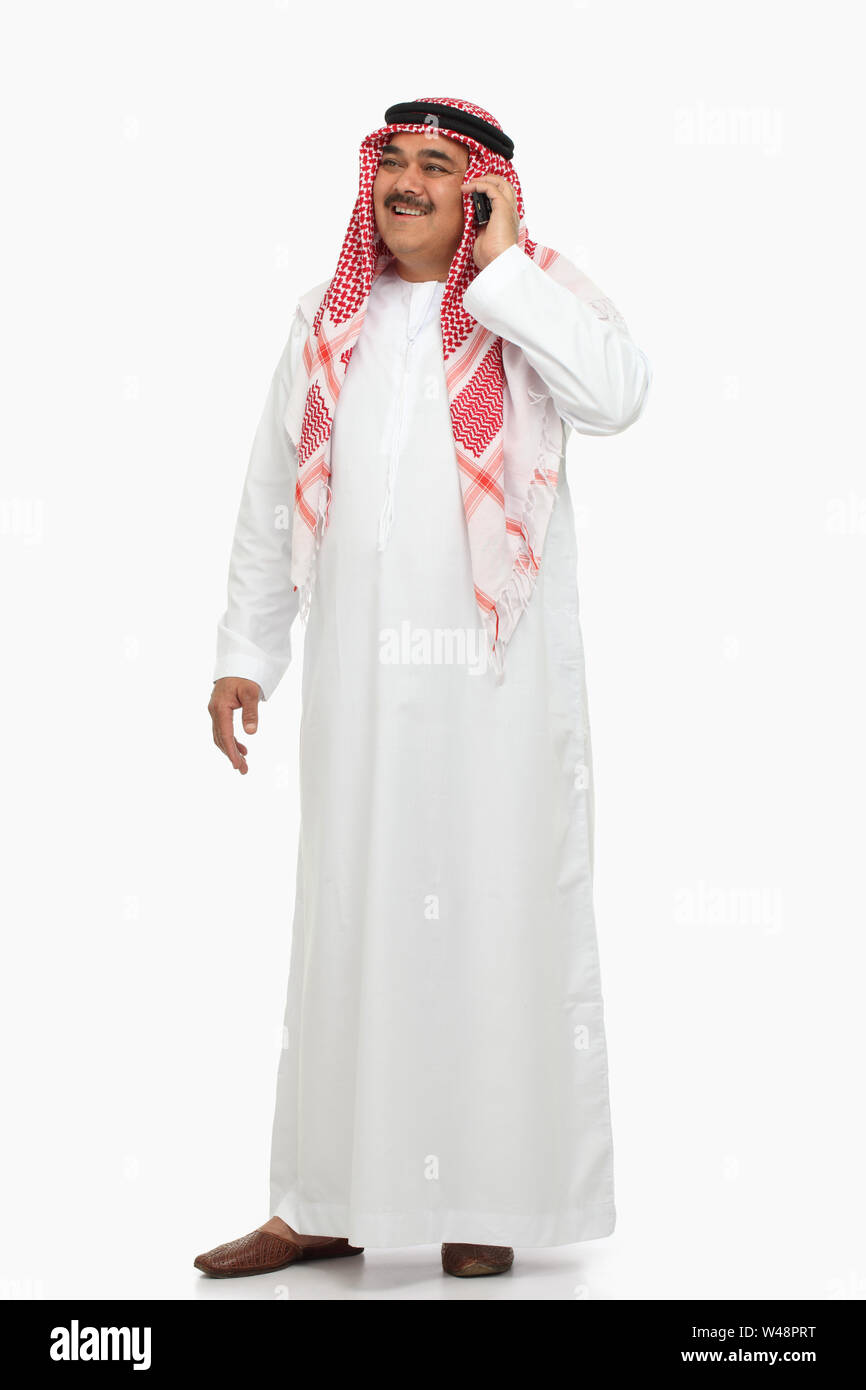 Arabian man talking on a mobile phone and smiling Stock Photo - Alamy