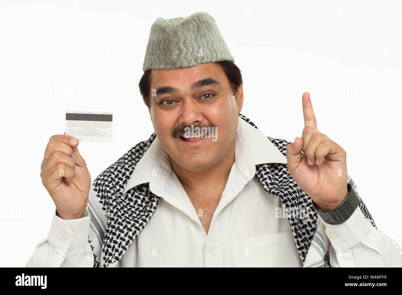 Muslim man showing credit card and pointing upward Stock Photo - Alamy