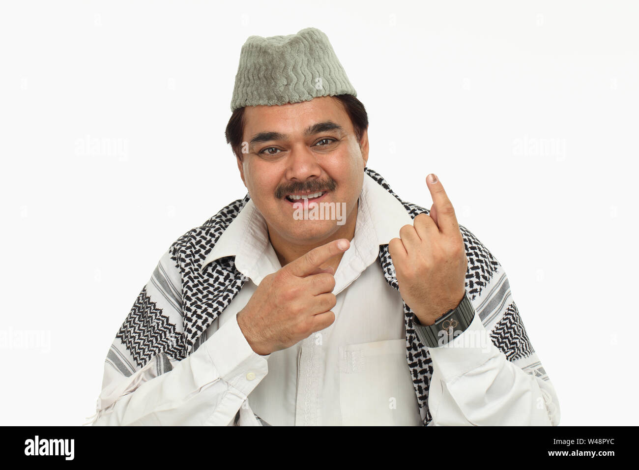 Muslim man pointing upward and smiling Stock Photo - Alamy
