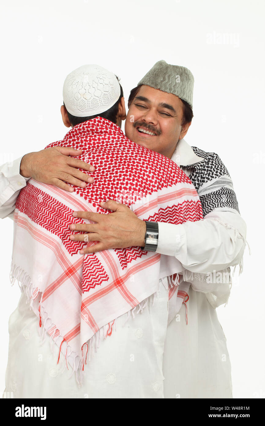 Muslim man hugging his son and smiling Stock Photo - Alamy