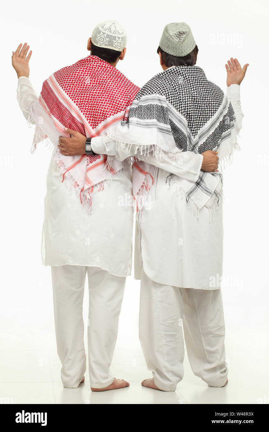 Rear view of two Muslim men praying Stock Photo - Alamy