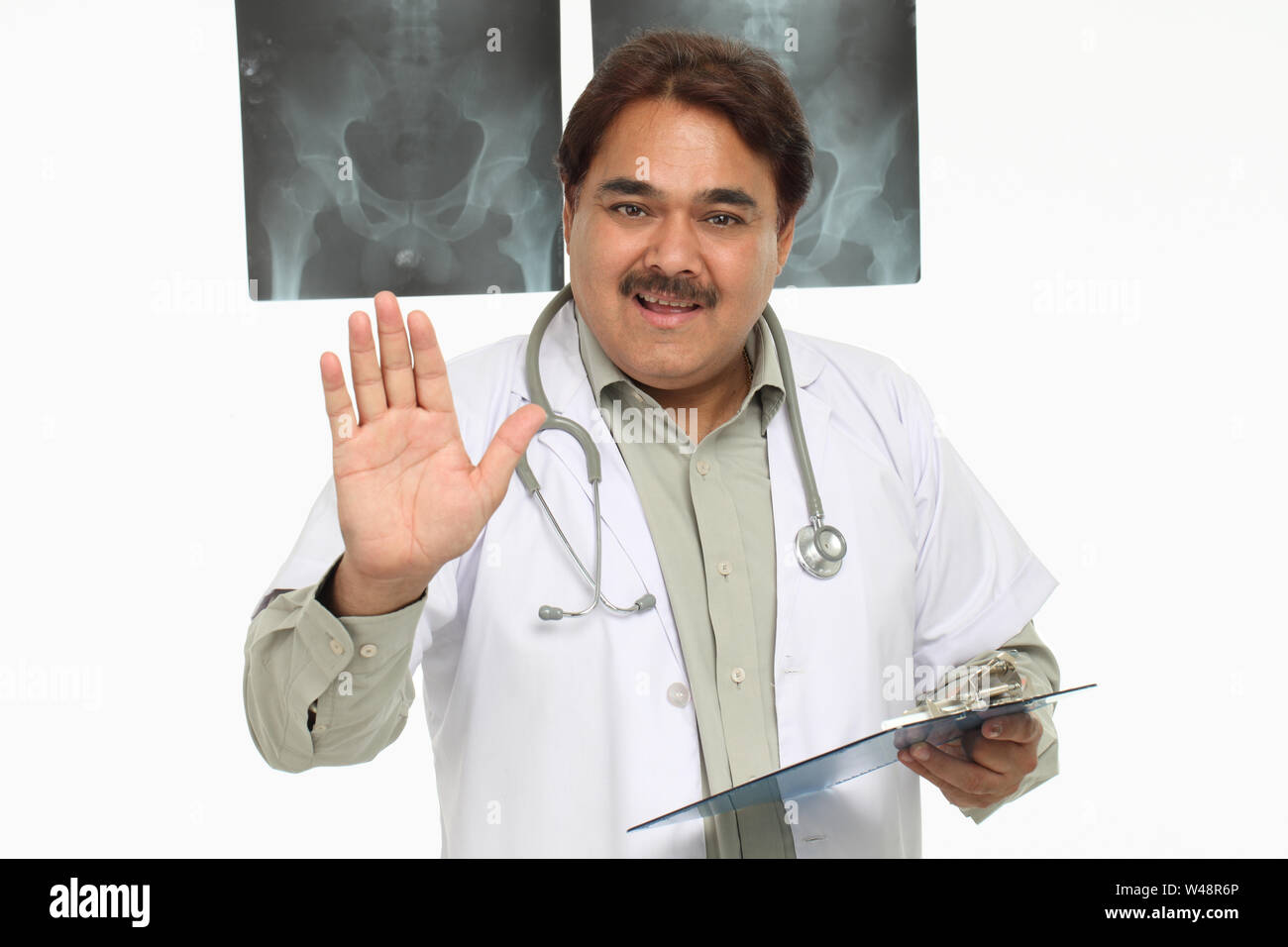 Portrait of an Indian male doctor writing prescription Stock Photo - Alamy
