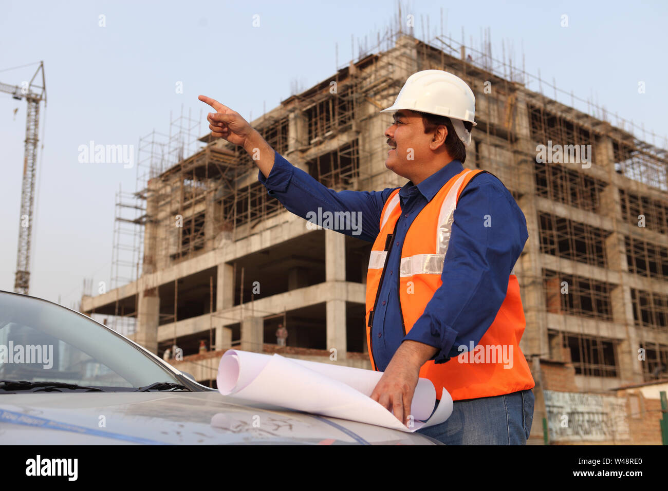 Architect pointing at construction site Stock Photo - Alamy