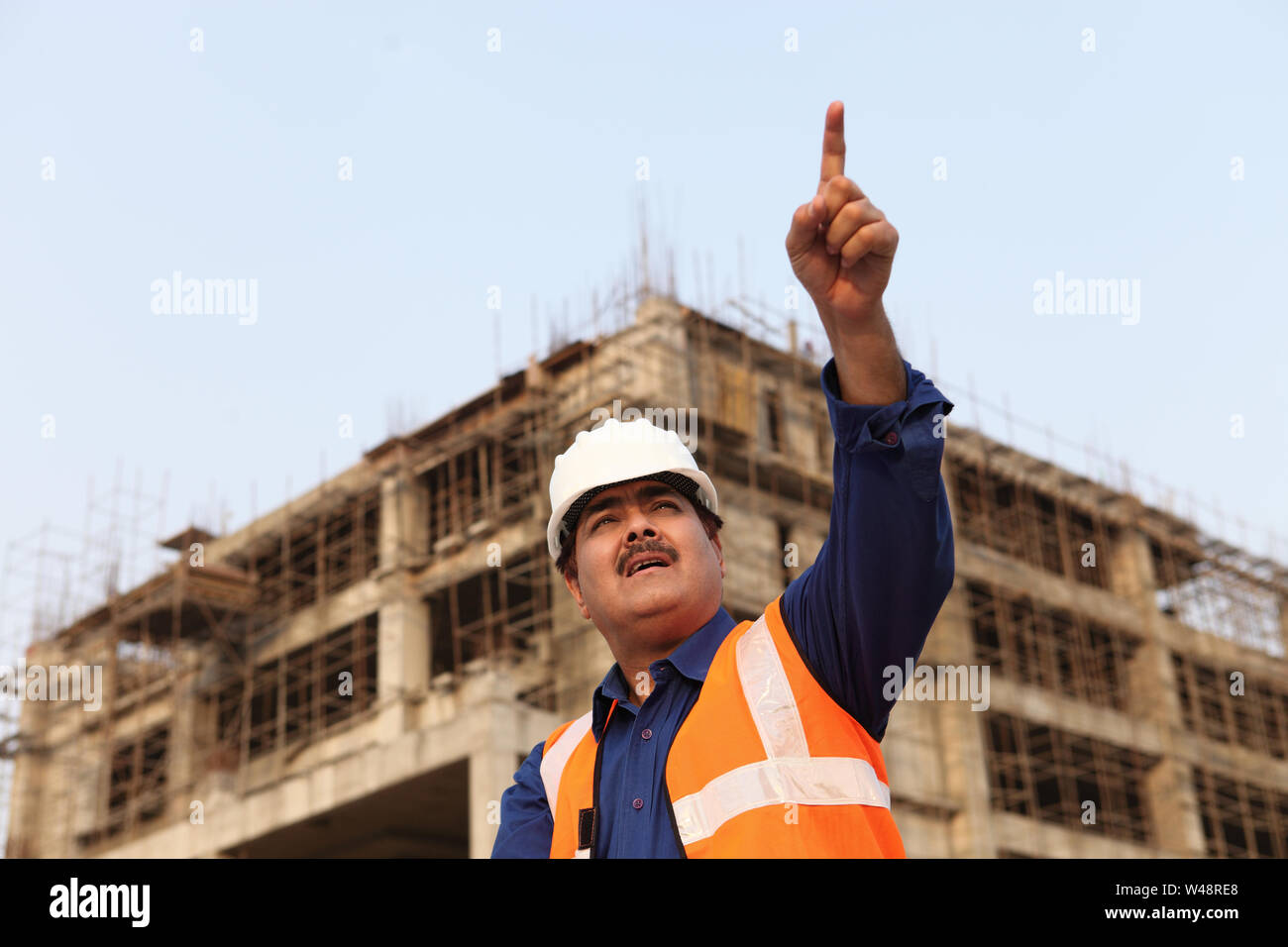 Architect pointing at construction site Stock Photo - Alamy