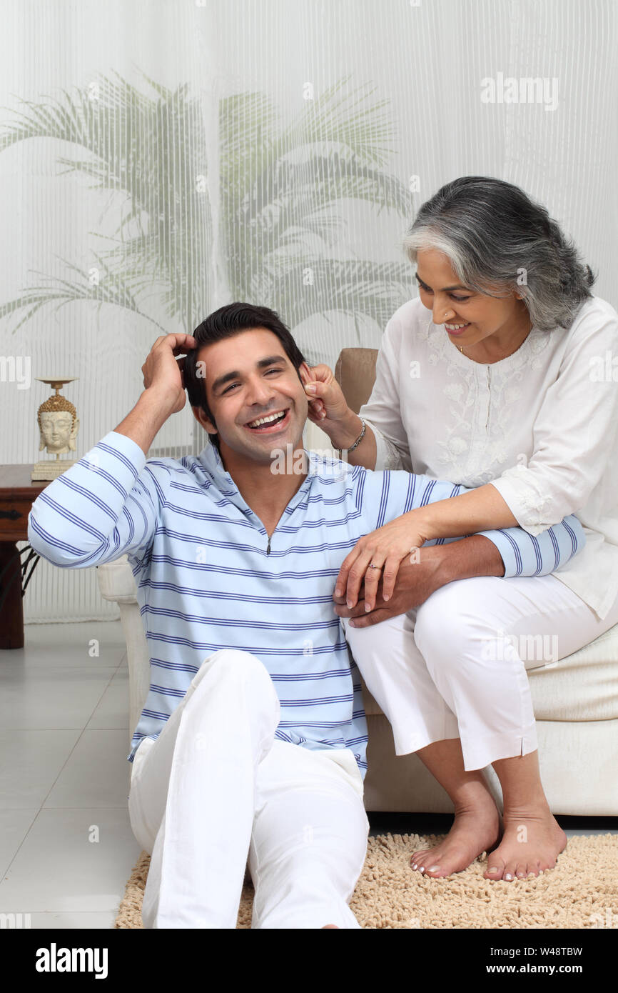 Senior woman pulling ear of her son Stock Photo - Alamy