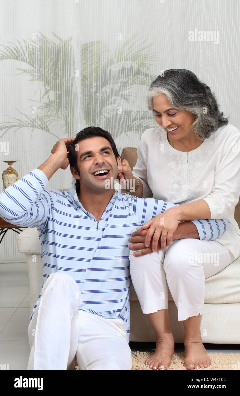 Indian senior woman pulling ear hi-res stock photography and images - Alamy