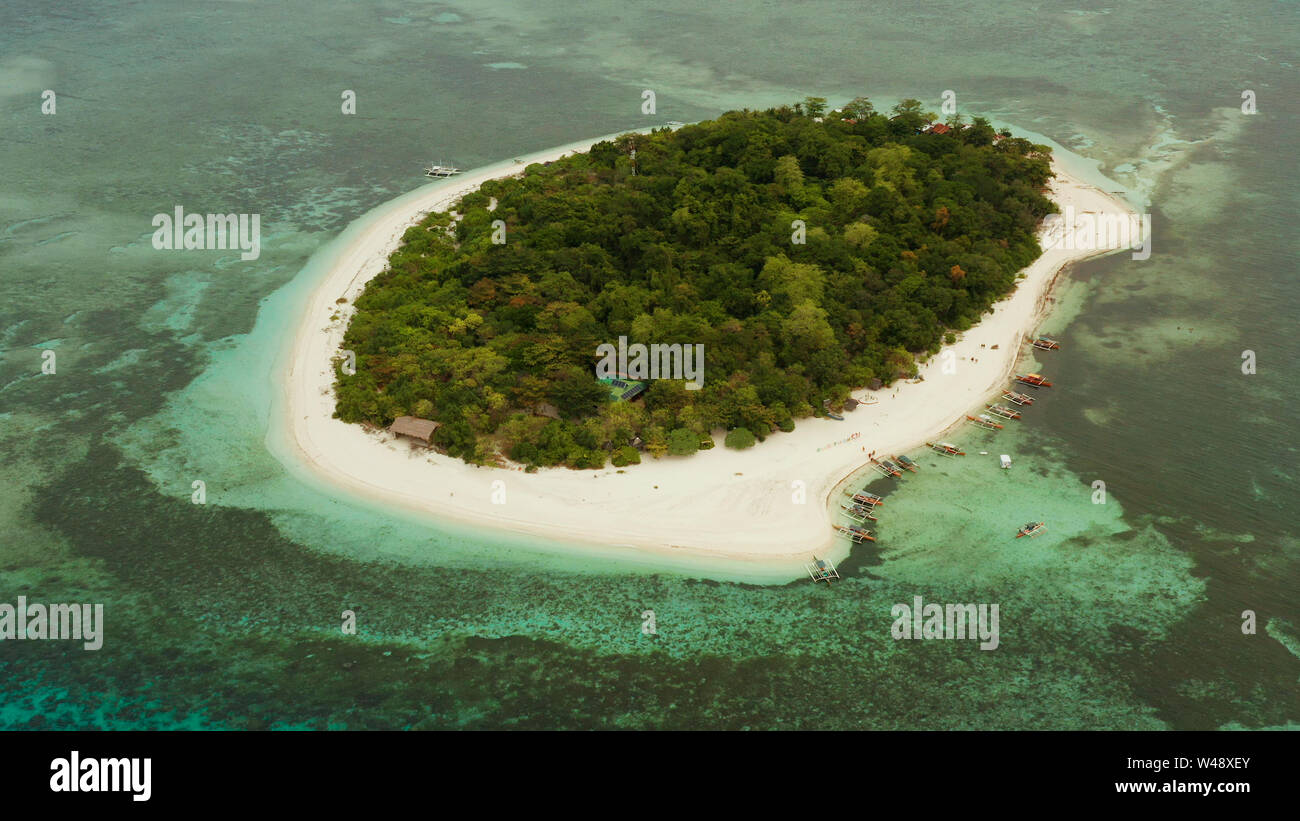 Beautiful beach on tropical island surrounded by coral reef, top view ...