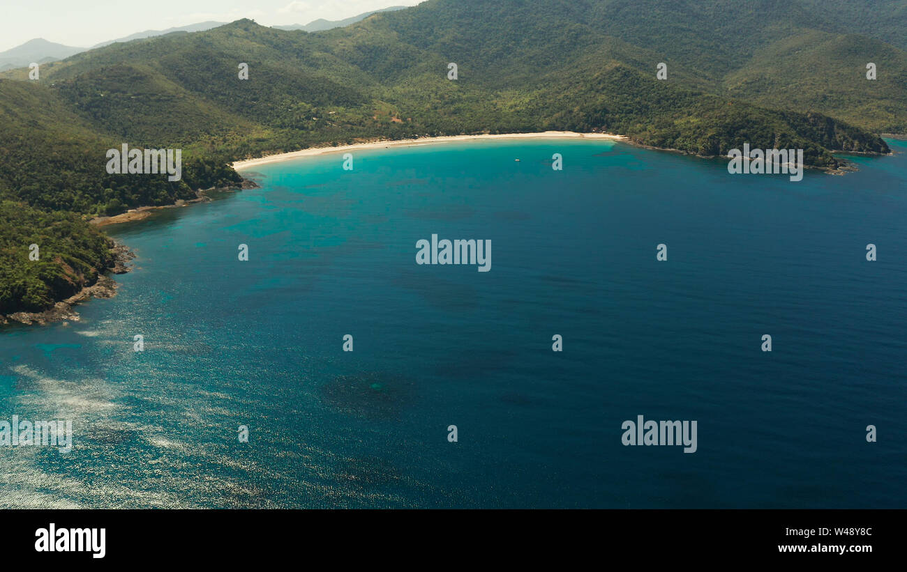 Aerial view beautiful tropical beach Nagtabon in the cove with blue ...