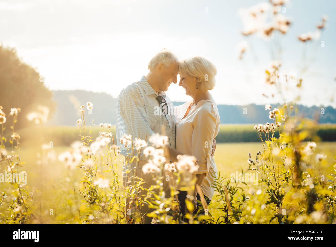 Senior woman and man hugging still being in love Stock Photo - Alamy