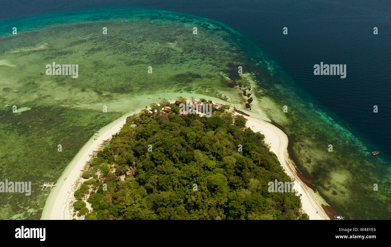 Tropical island in the blue sea with coral reef, top view. Small island ...