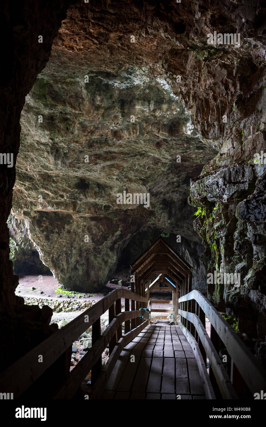 A wooden bridge at the entrance of Smoo Cave, a large combined sea cave ...