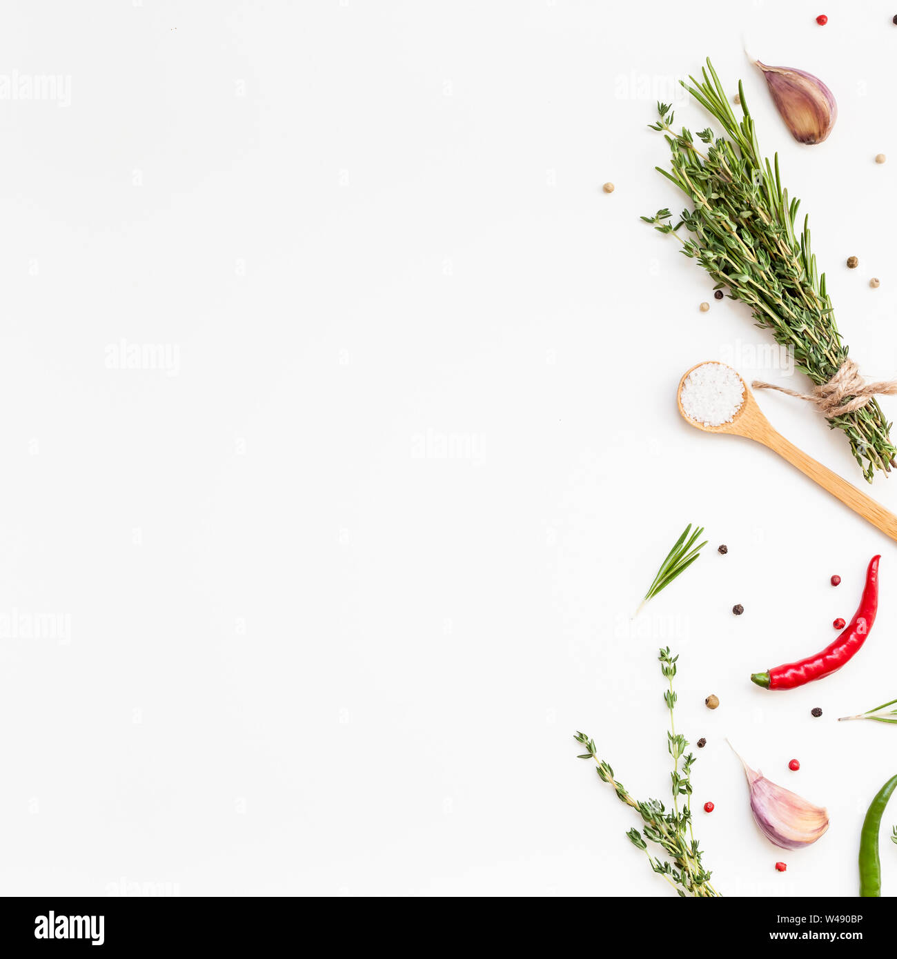 Flat lay overhead top view of greens herbs and spices on white ...