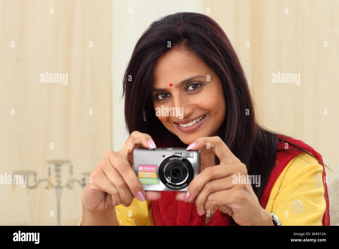 Indian woman taking picture with digital camera Stock Photo - Alamy