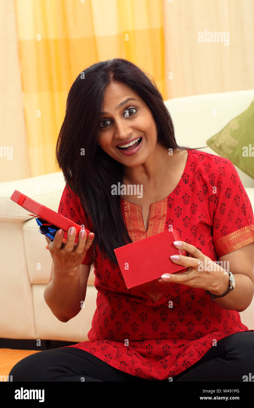 Woman opening a gift box Stock Photo - Alamy