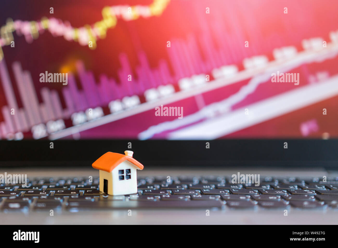 Growing home sale grap. model of the house on the background of growth ...