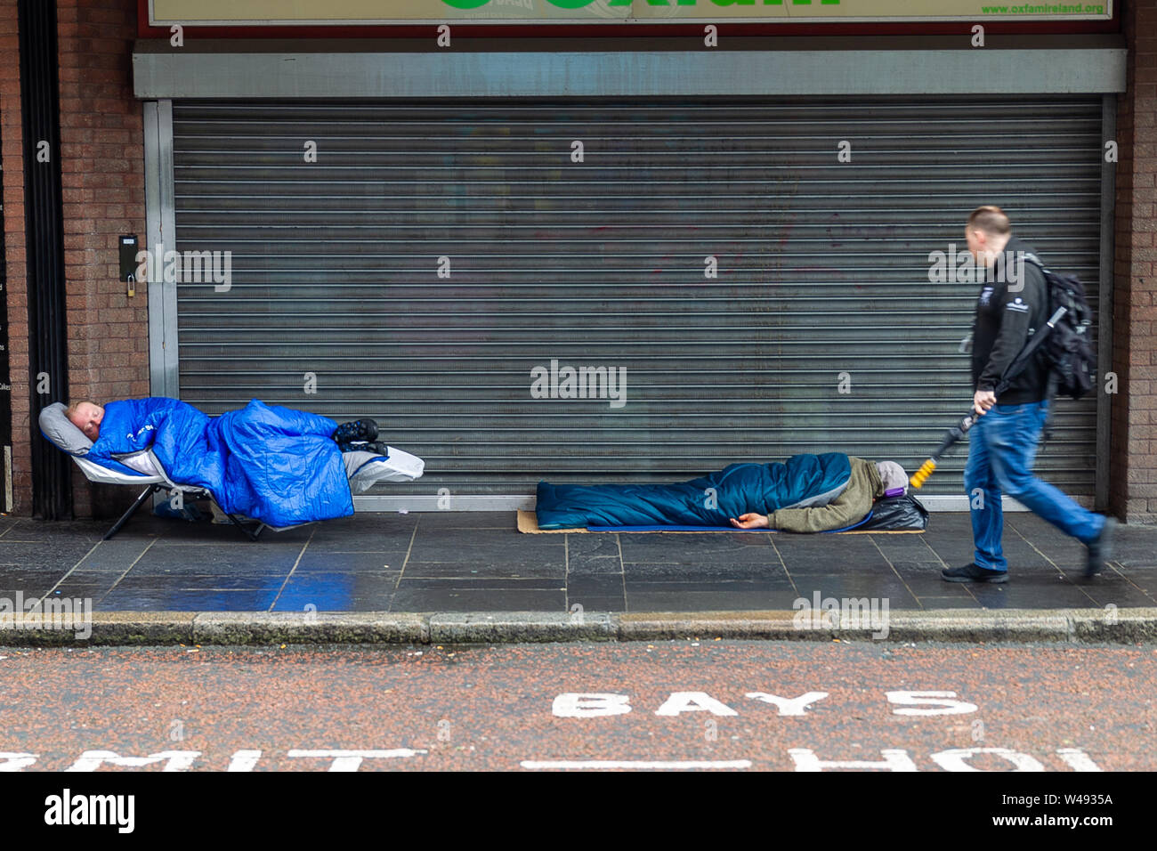 Homeless man sleeping in shop window hi-res stock photography and ...