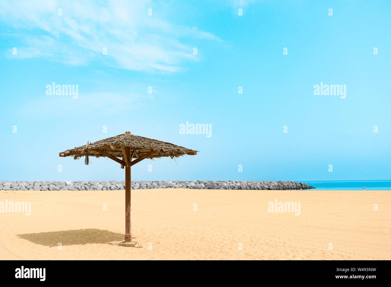Thatched Parasol on an empty Gold Beach. Al Mamzar, Dubai, Emirates ...