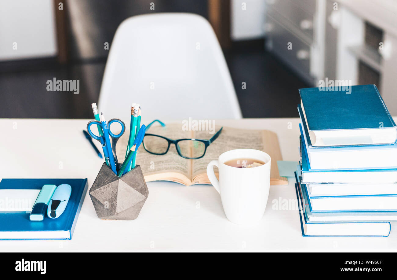 Modern stylish office work place with open book, glasses, office ...