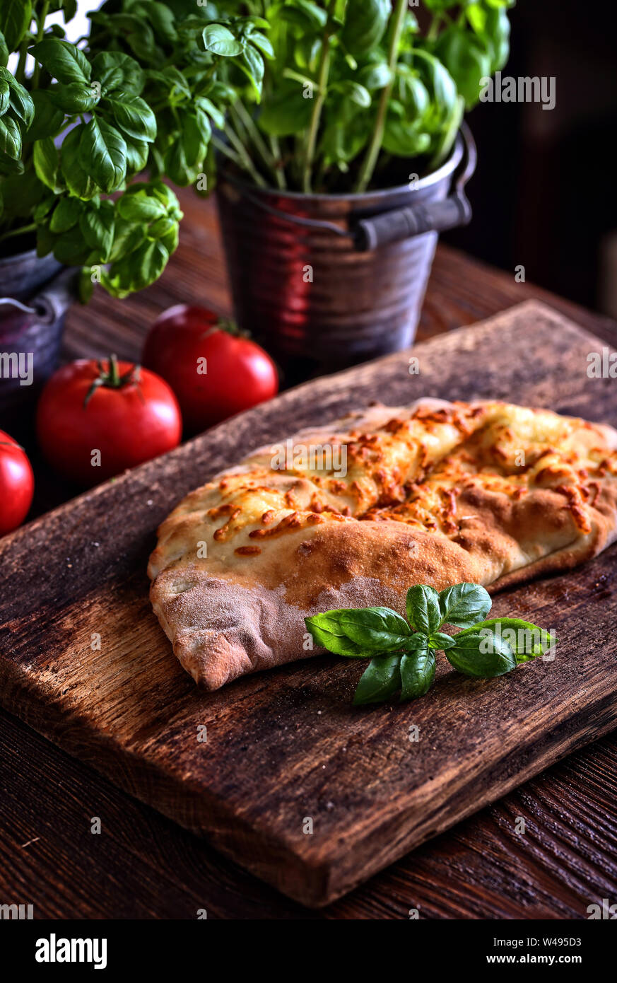 homemade calzone on a wooden board Stock Photo - Alamy