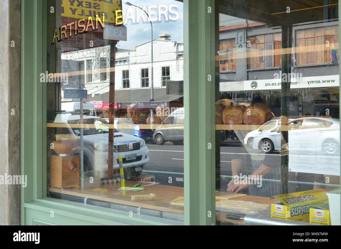 View of K'Rd Reflected on Bakery's Windows Stock Photo - Alamy