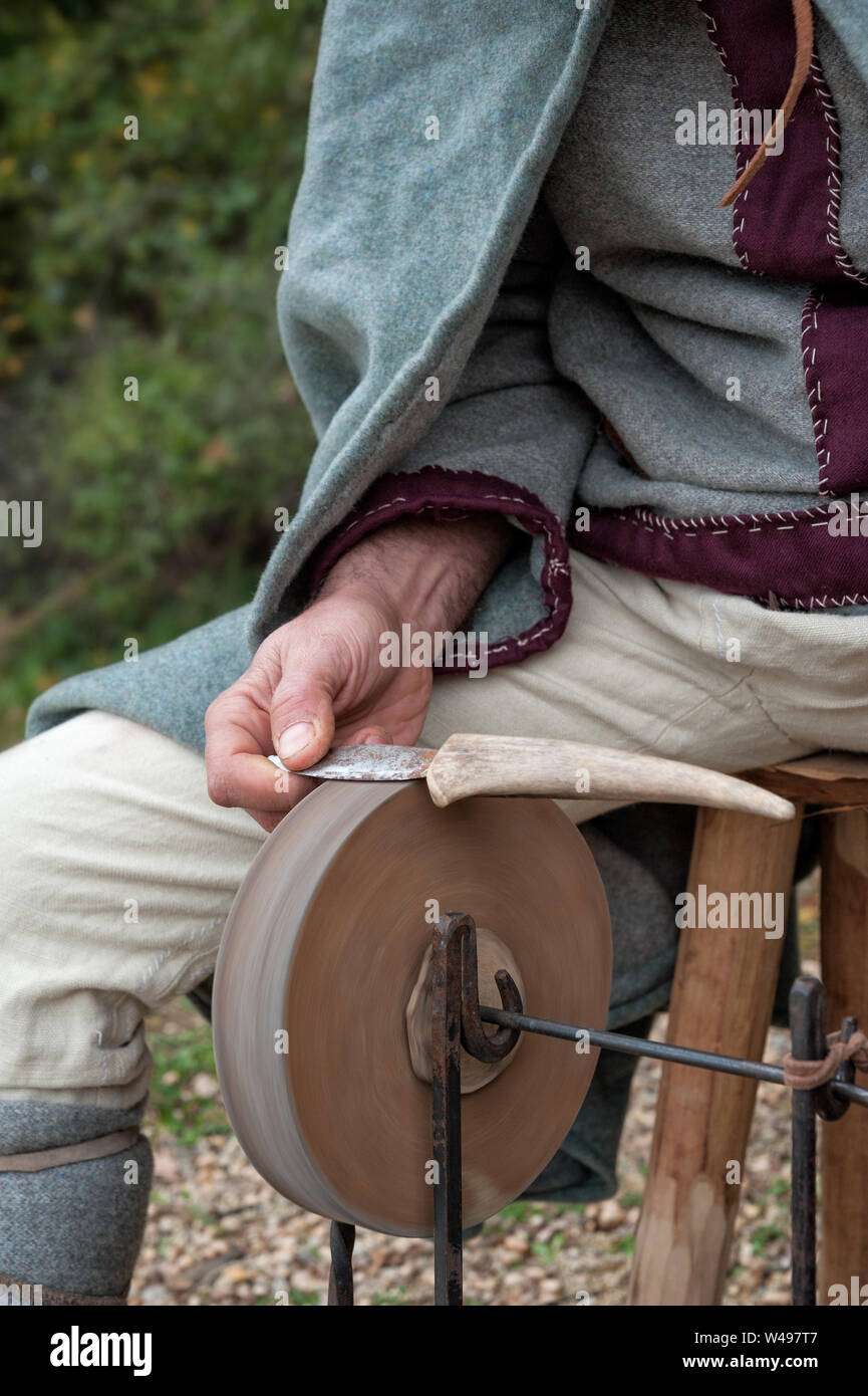 The knife grinder works in a small medieval village Stock Photo - Alamy