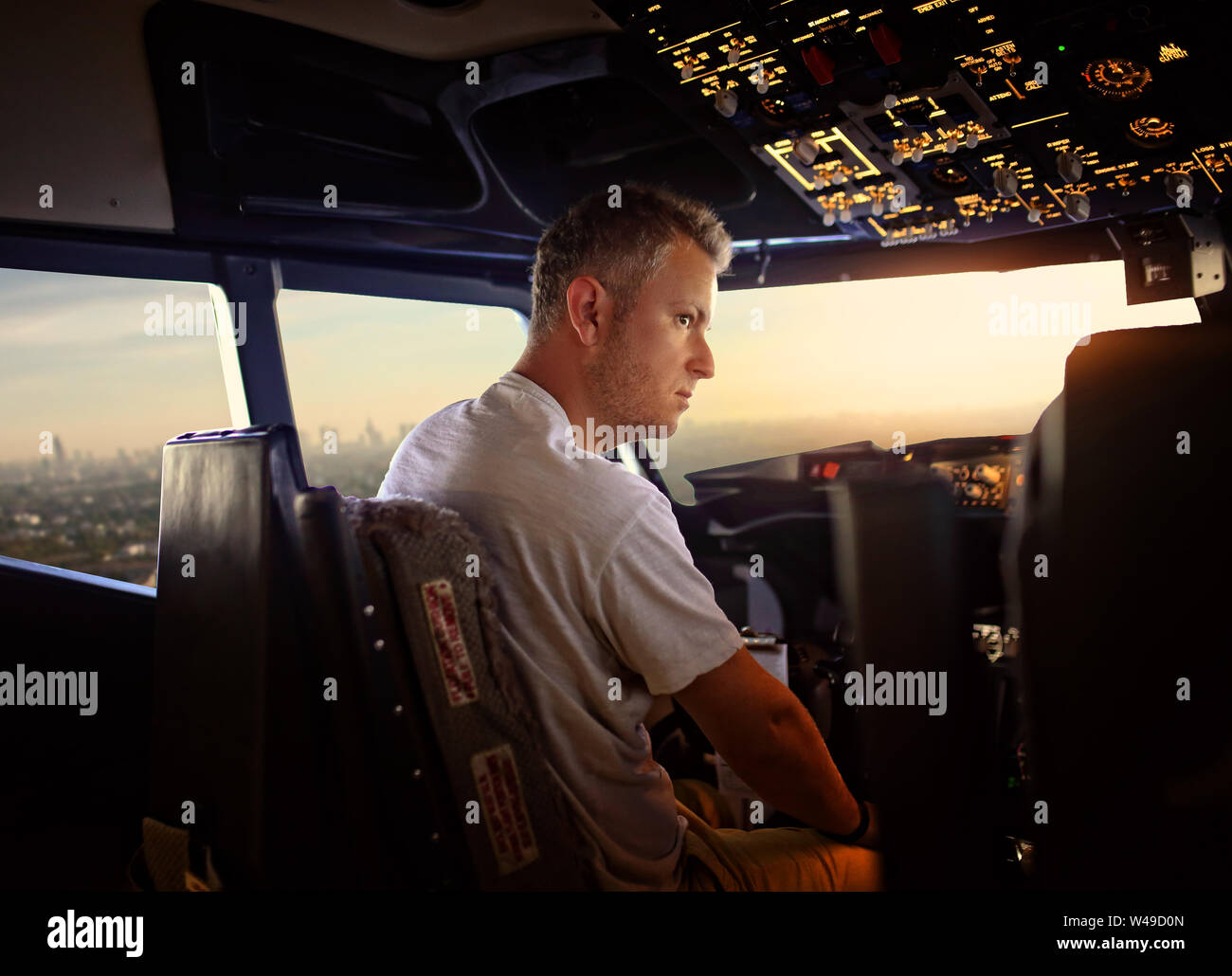 experienced young pilot in the cockpit of the plane Stock Photo - Alamy
