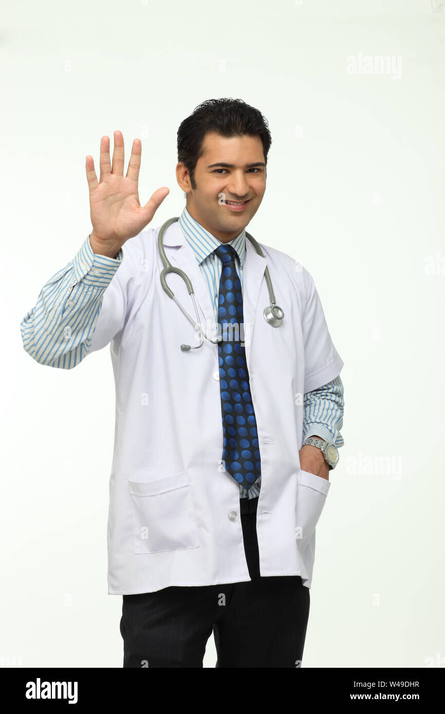 Portrait of a male doctor waving hand Stock Photo - Alamy