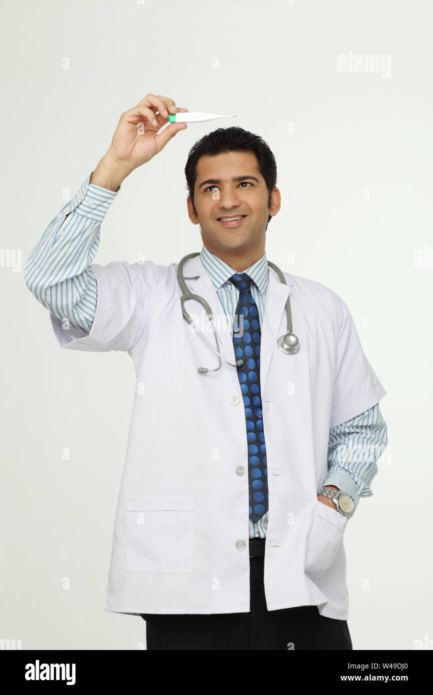 Male doctor checking his patient temperature Stock Photo - Alamy