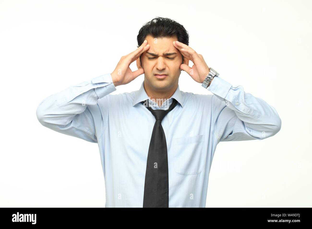 Indian businessman suffering from headache Stock Photo - Alamy