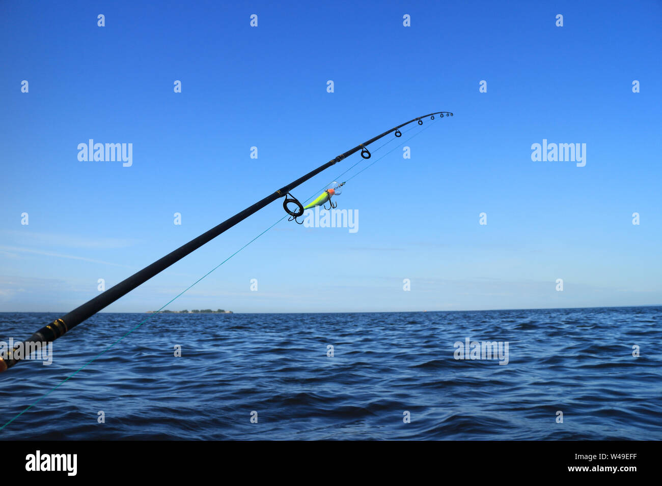 rod with crank bait for catching predatory fish aboard a boat against ...