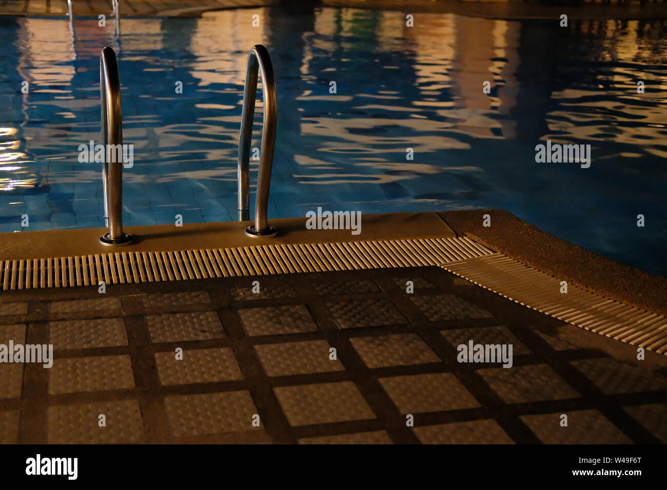 metal steel handle at edge poolside of swimming pool in hotel resort at ...