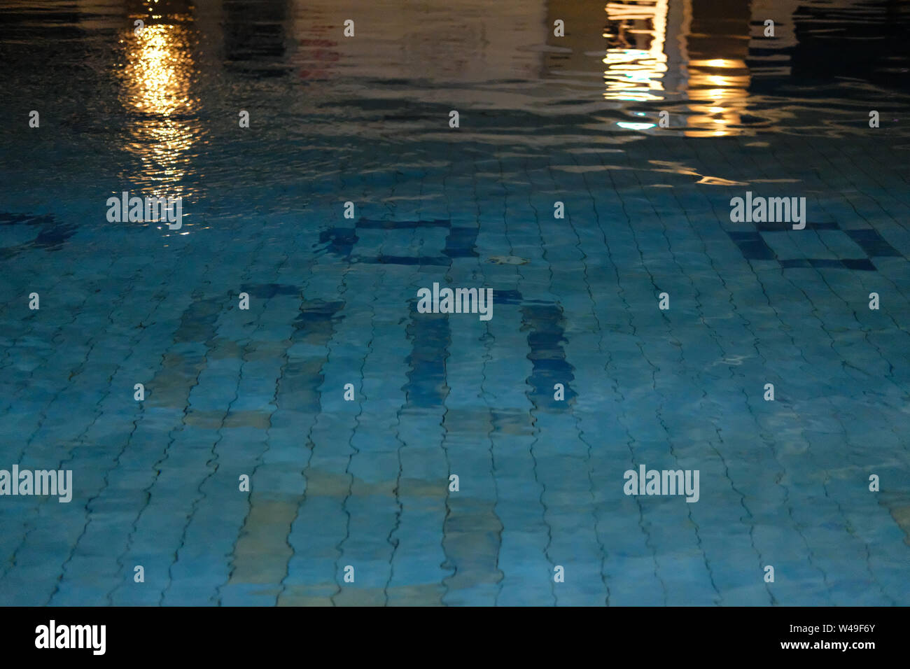 water surface of green swimming pool in hotel at night Stock Photo - Alamy