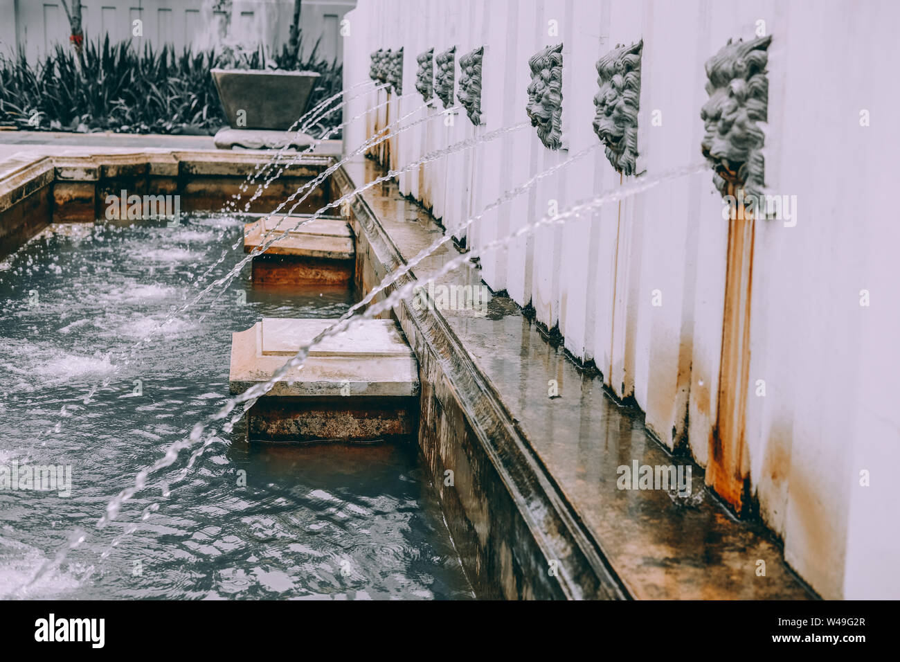 water flowing from lion head statue sculpture Stock Photo - Alamy