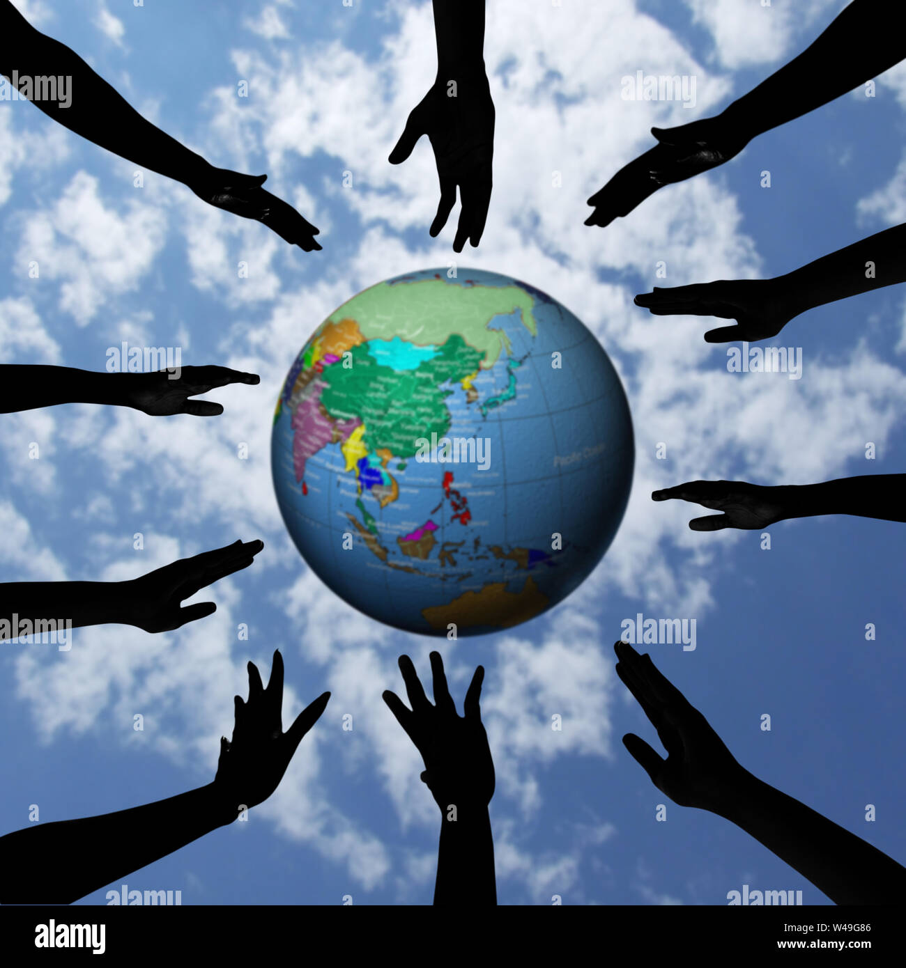 Low angle view of person hand touching globe Stock Photo - Alamy