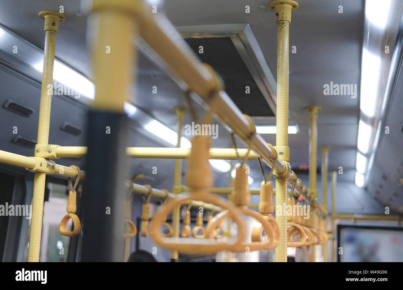 yellow handle on commuter bus. public transport Stock Photo - Alamy