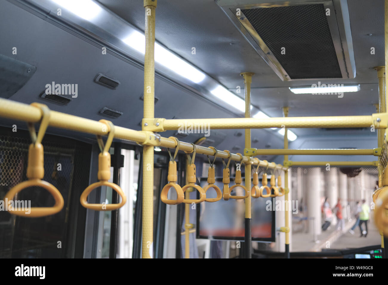 yellow handle on commuter bus. public transport Stock Photo - Alamy