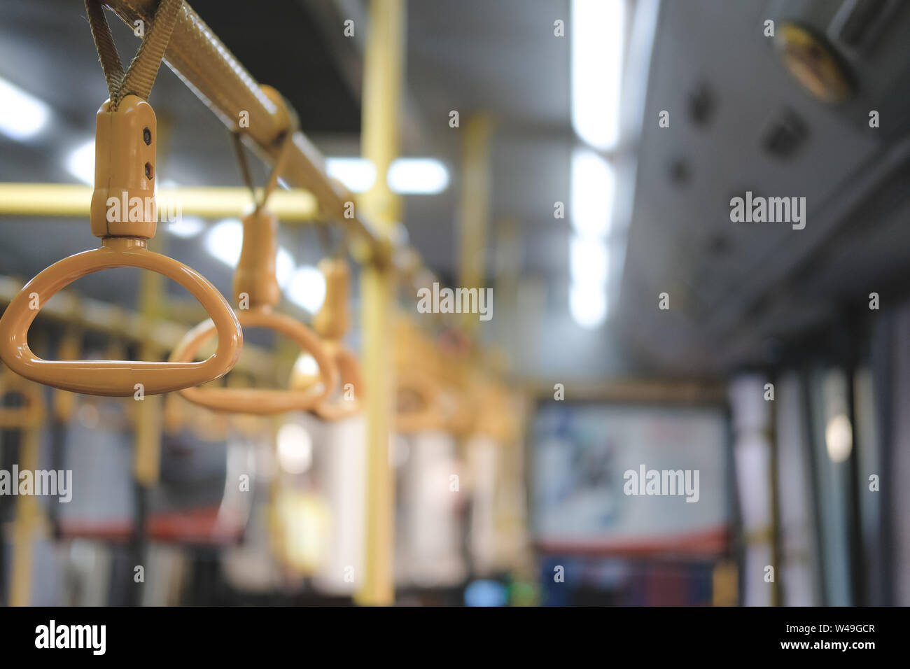 yellow handle on commuter bus. public transport Stock Photo - Alamy